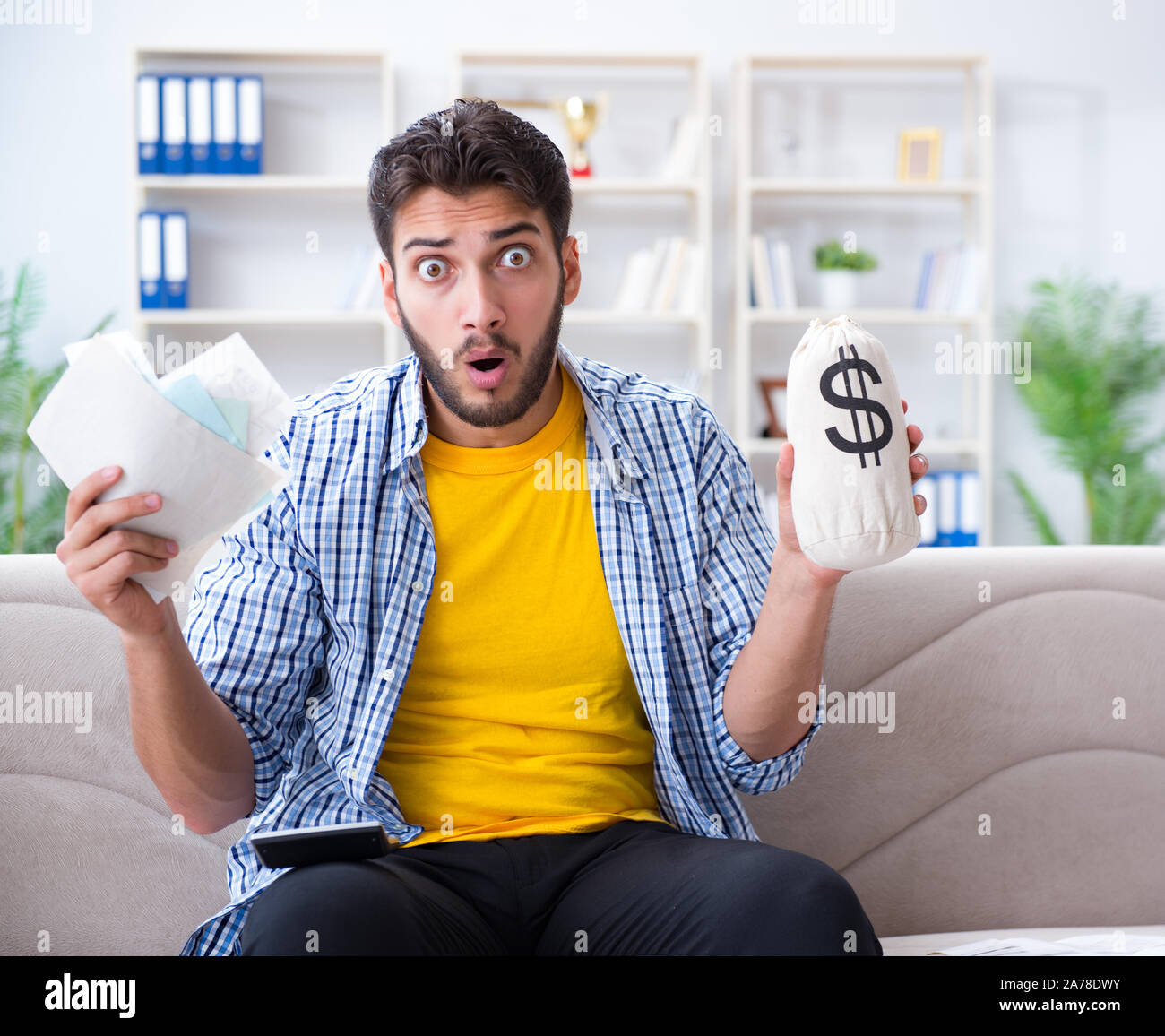 The man angry at bills he needs to pay Stock Photo - Alamy