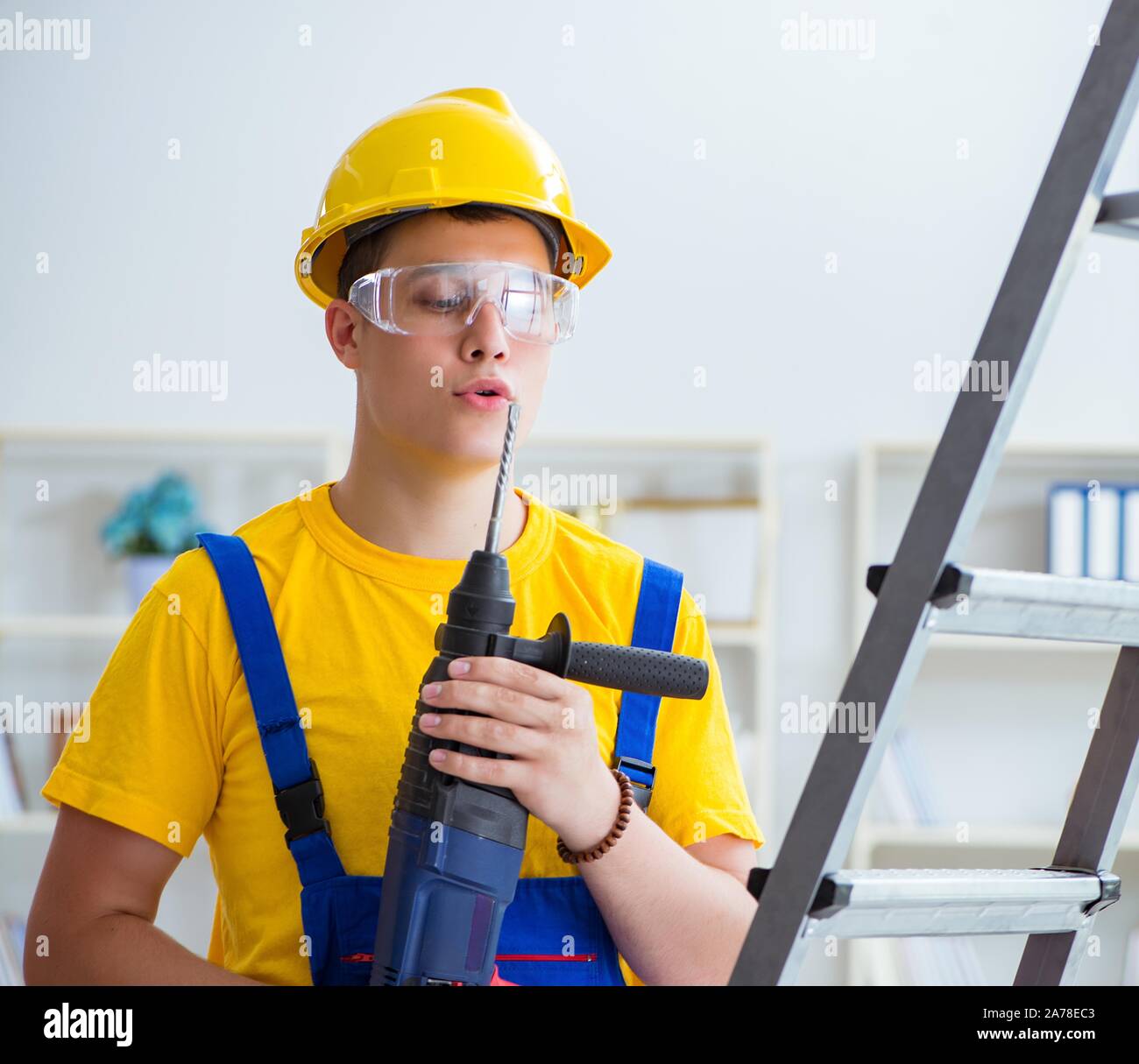 The young repairman with power drill Stock Photo - Alamy