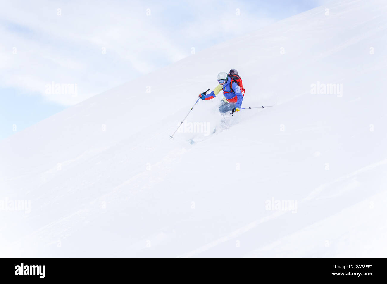 Side photo of sports man with backpack skiing in winter resort Stock ...