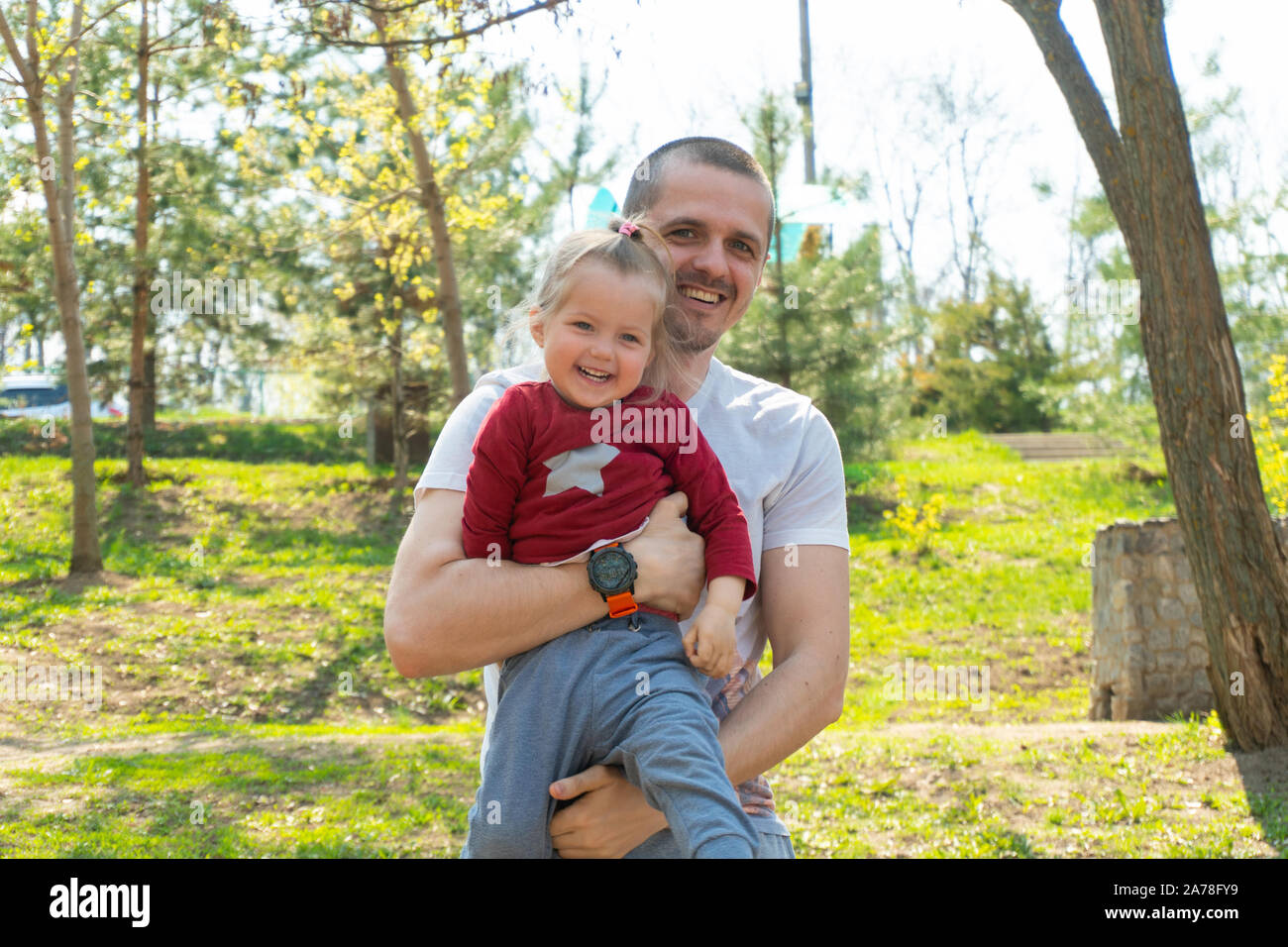 Father and daughter looking in camera and smiling Stock Photo - Alamy