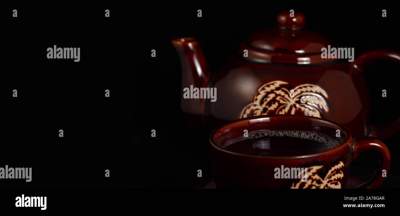 Tropical Black tea - Tea with cup saucer and tea pot Stock Photo - Alamy