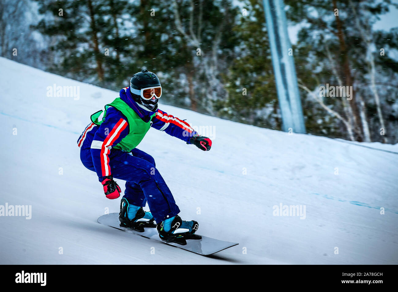 male rider complete a downhill in snowboard racing Stock Photo - Alamy