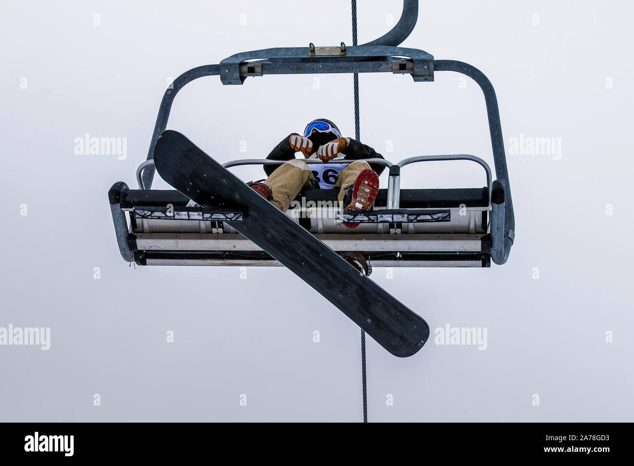 athlete snowboarder climb cable car to start of competition Stock Photo ...