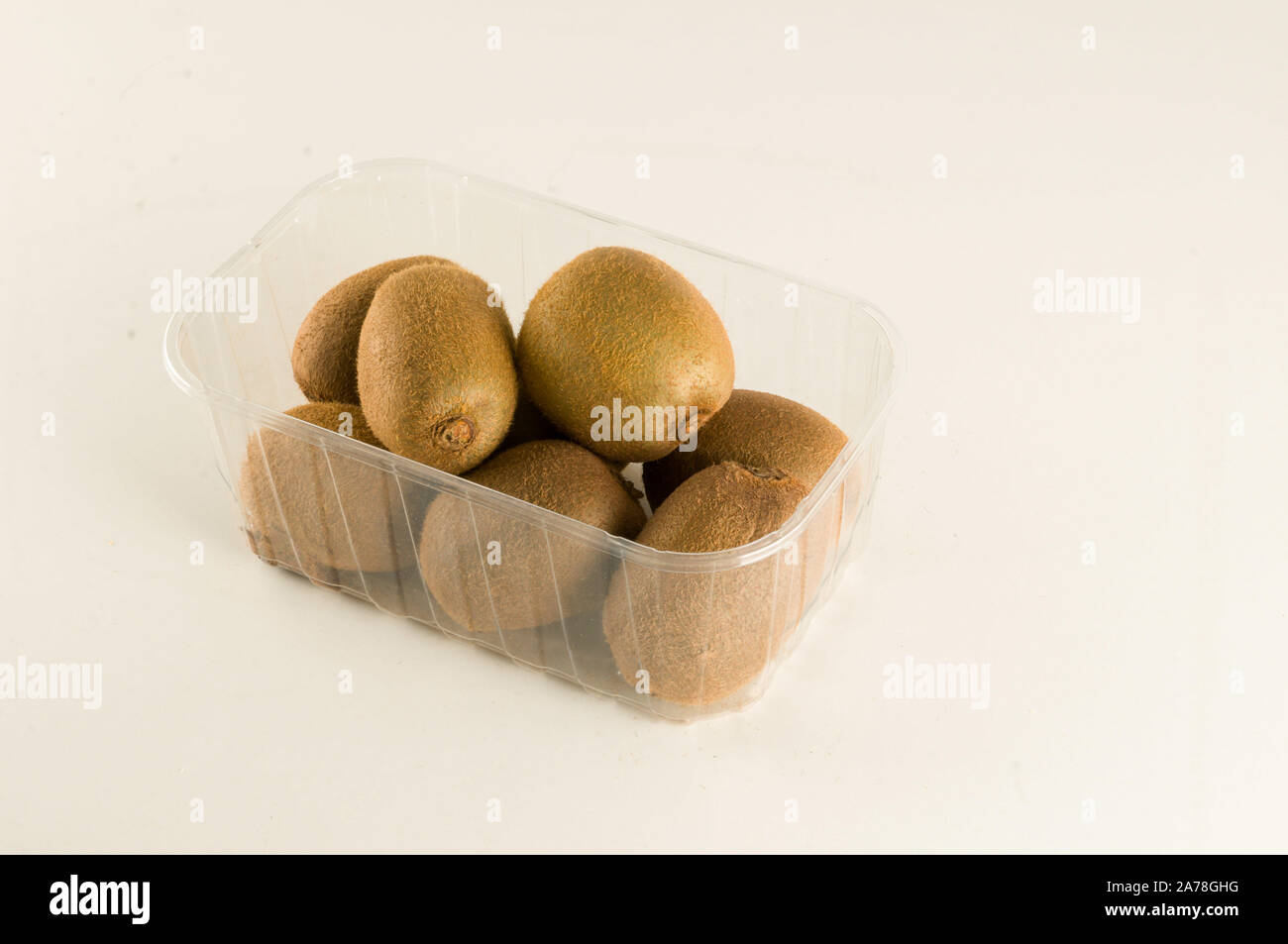Kiwi in a box isolated on white background Stock Photo - Alamy