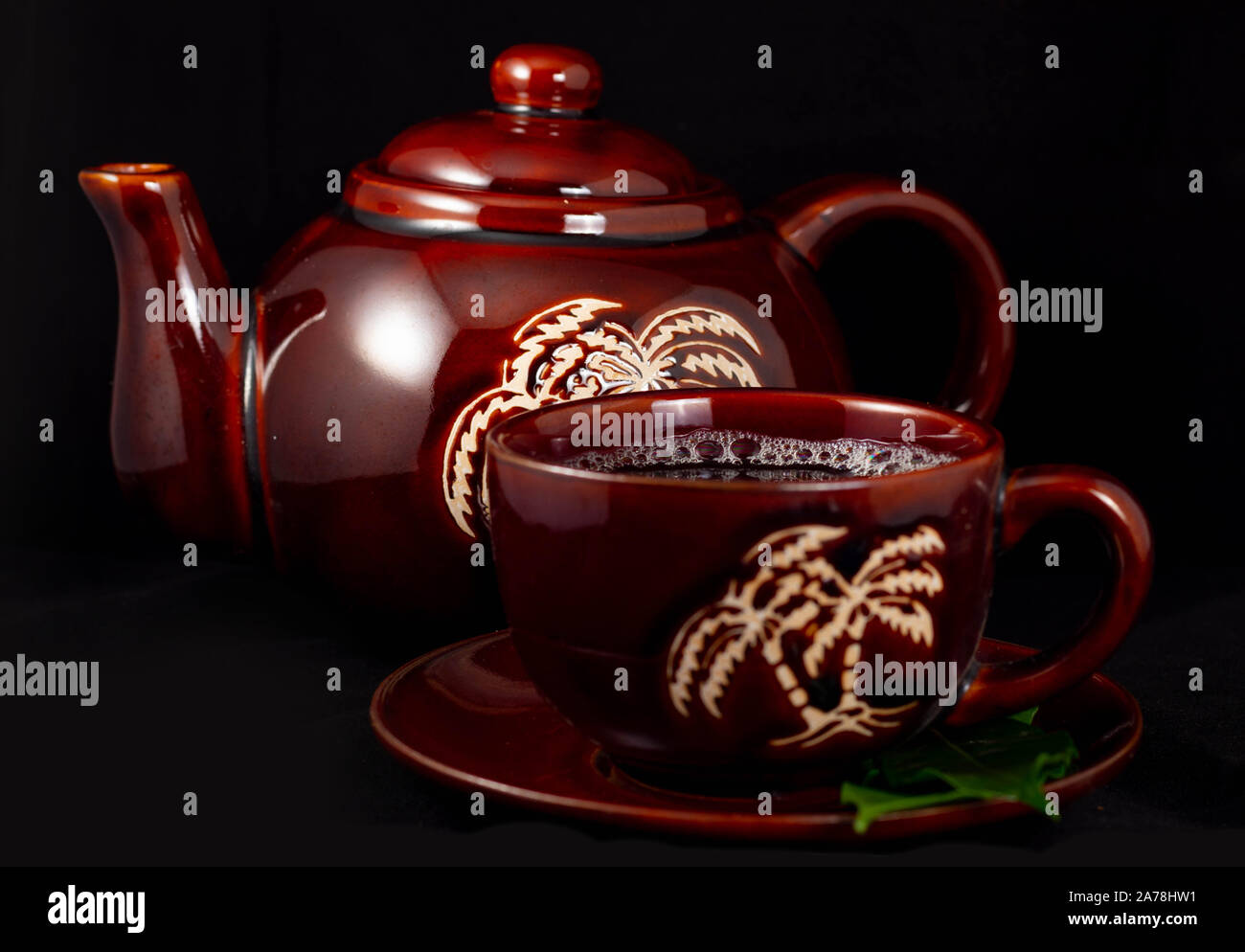 Tropical Black tea - Tea with cup saucer and tea pot Stock Photo - Alamy