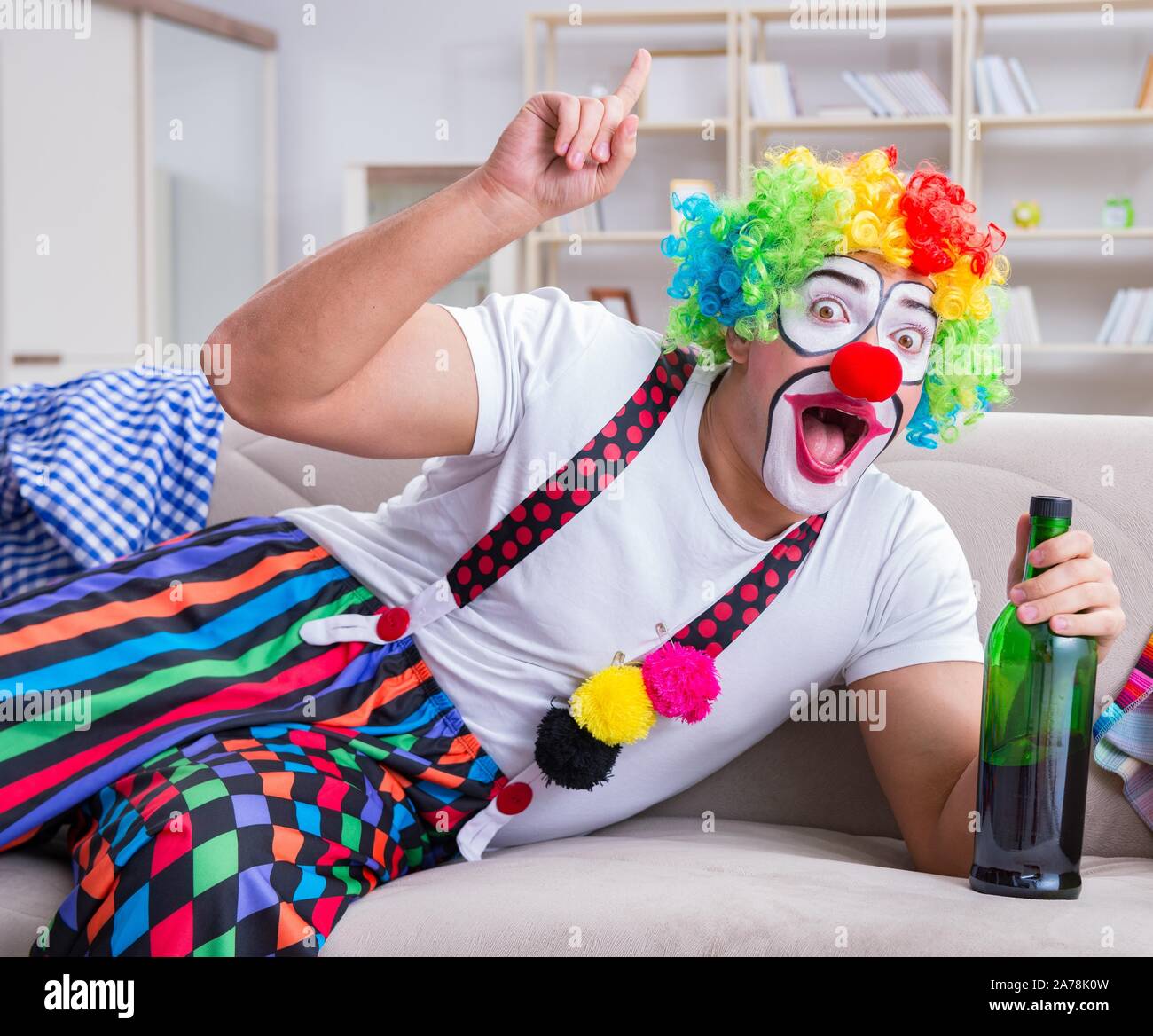 The drunk clown celebrating having a party at home Stock Photo - Alamy