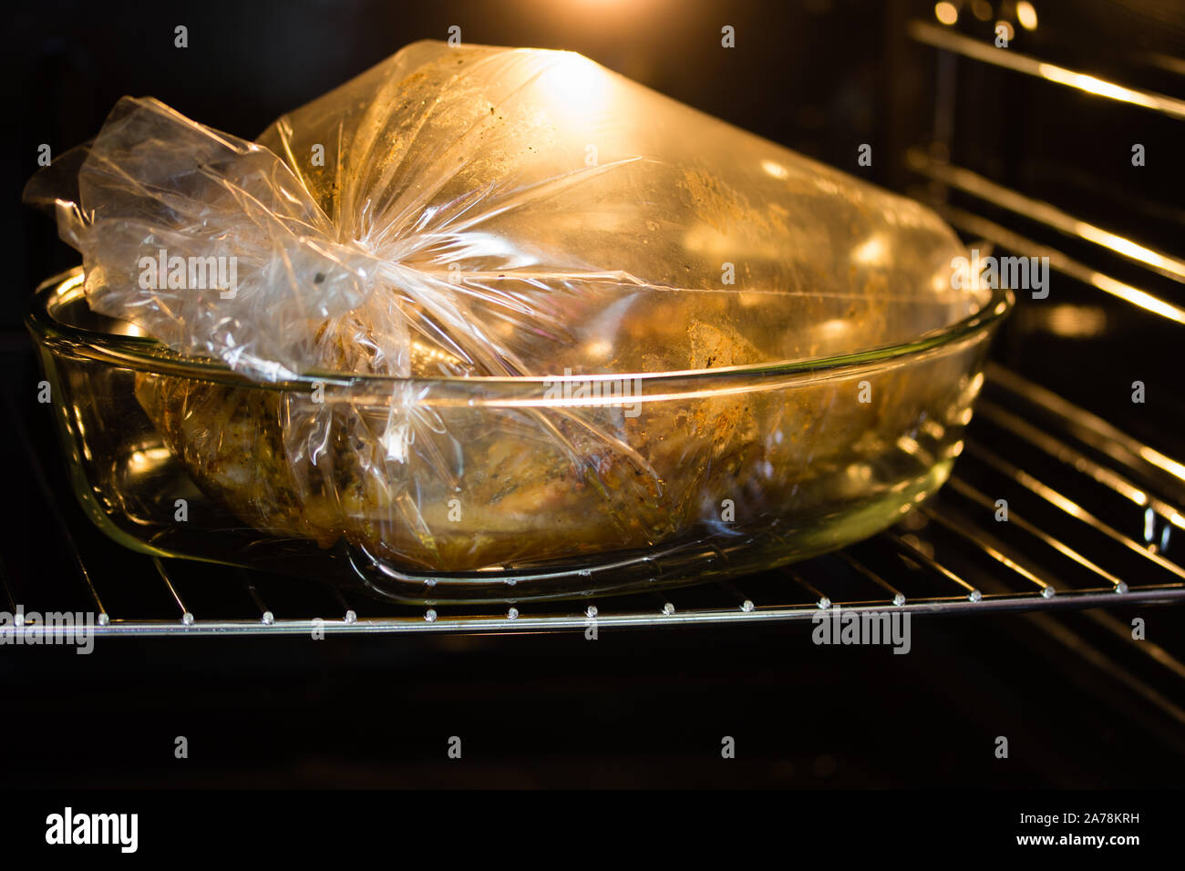 cooking bag with chicken in the oven Stock Photo - Alamy