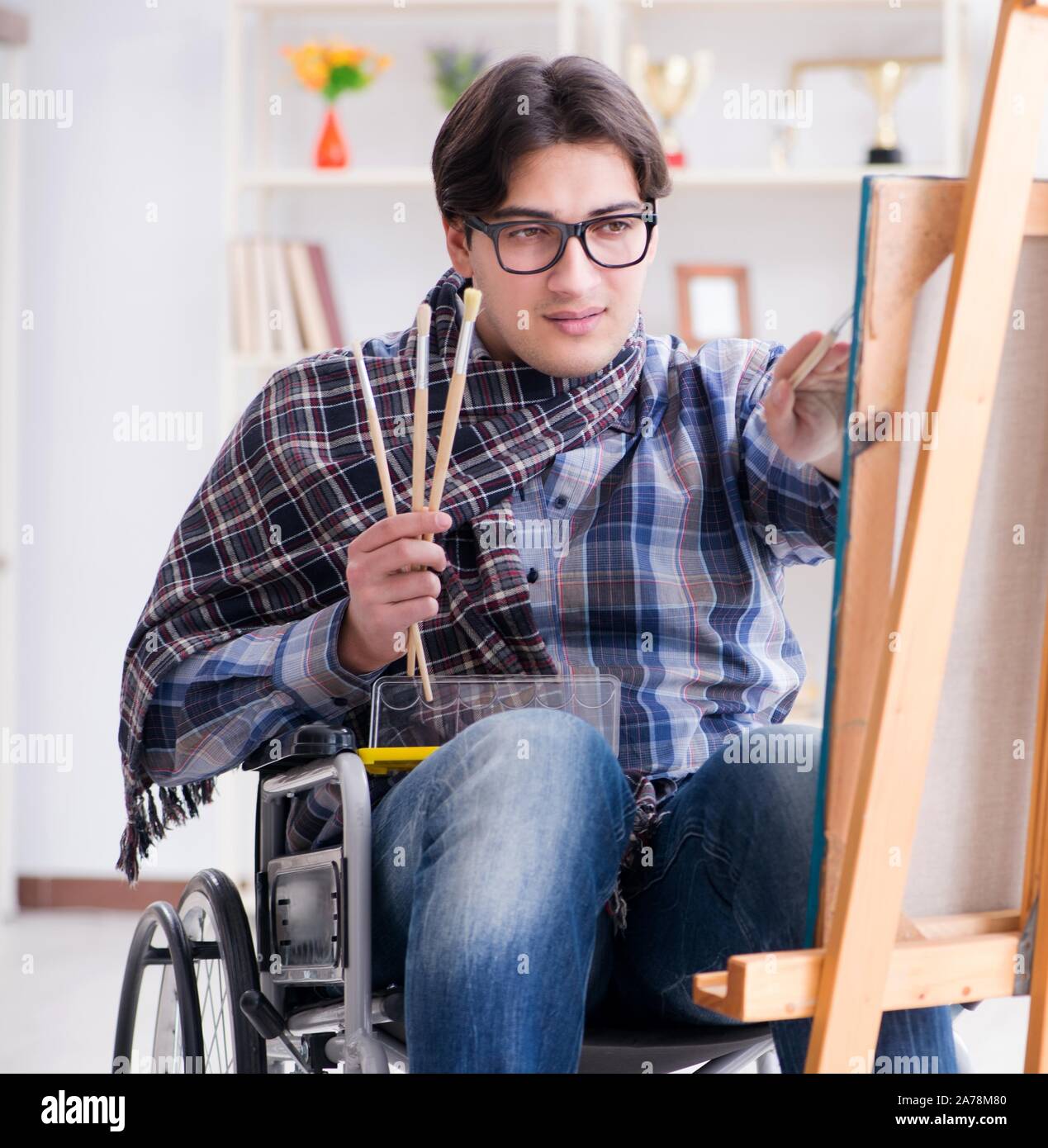 The disabled artist painting picture in studio Stock Photo - Alamy