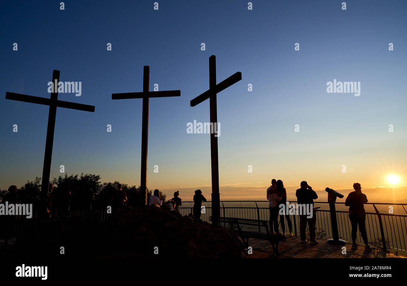 Visitors take photographs as the sun sets looking across Lake Como ...