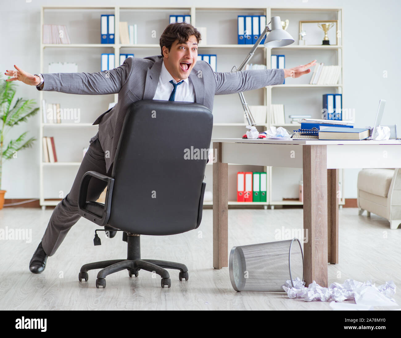 The businessman having fun taking a break in the office at work Stock ...