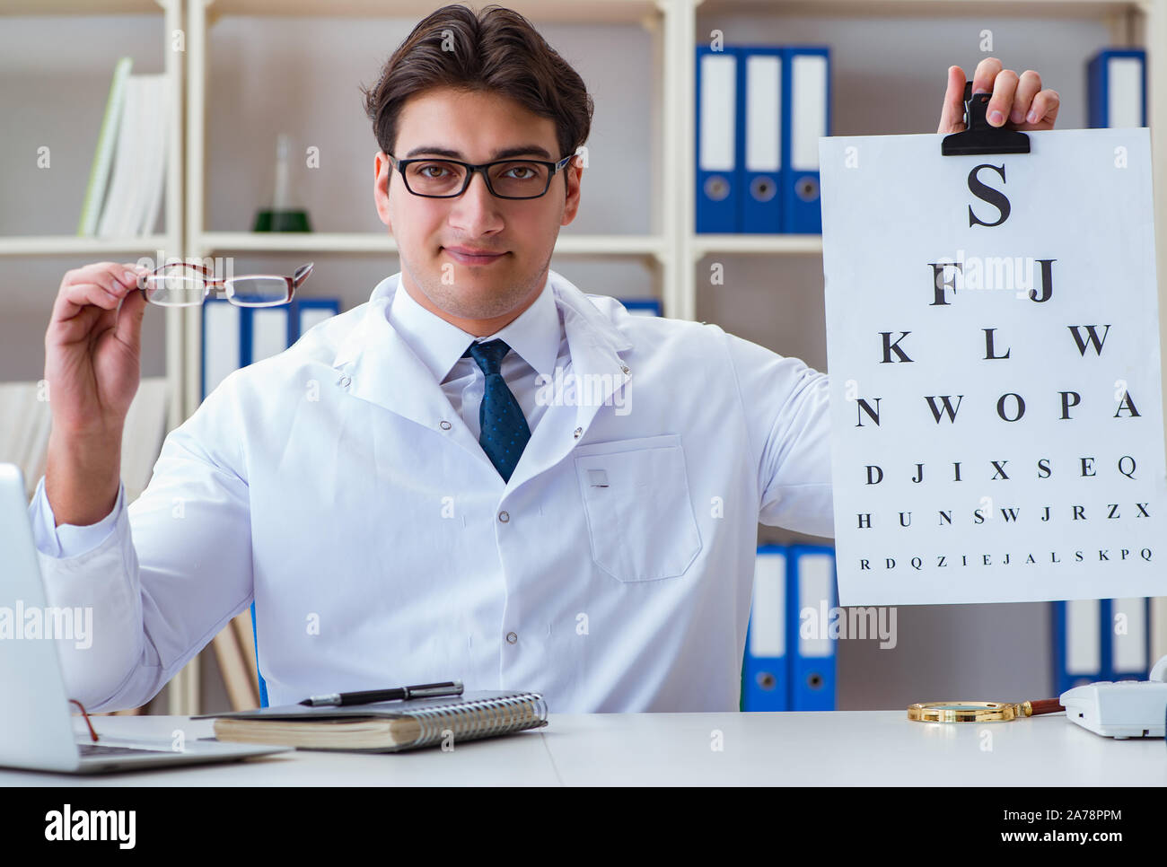 The doctor optician with letter chart conducting an eye test check ...