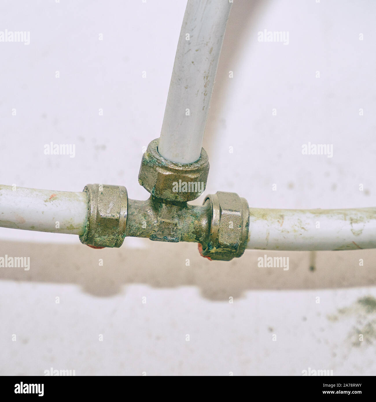 Old connection fitting tee on plastic water pipes Stock Photo - Alamy