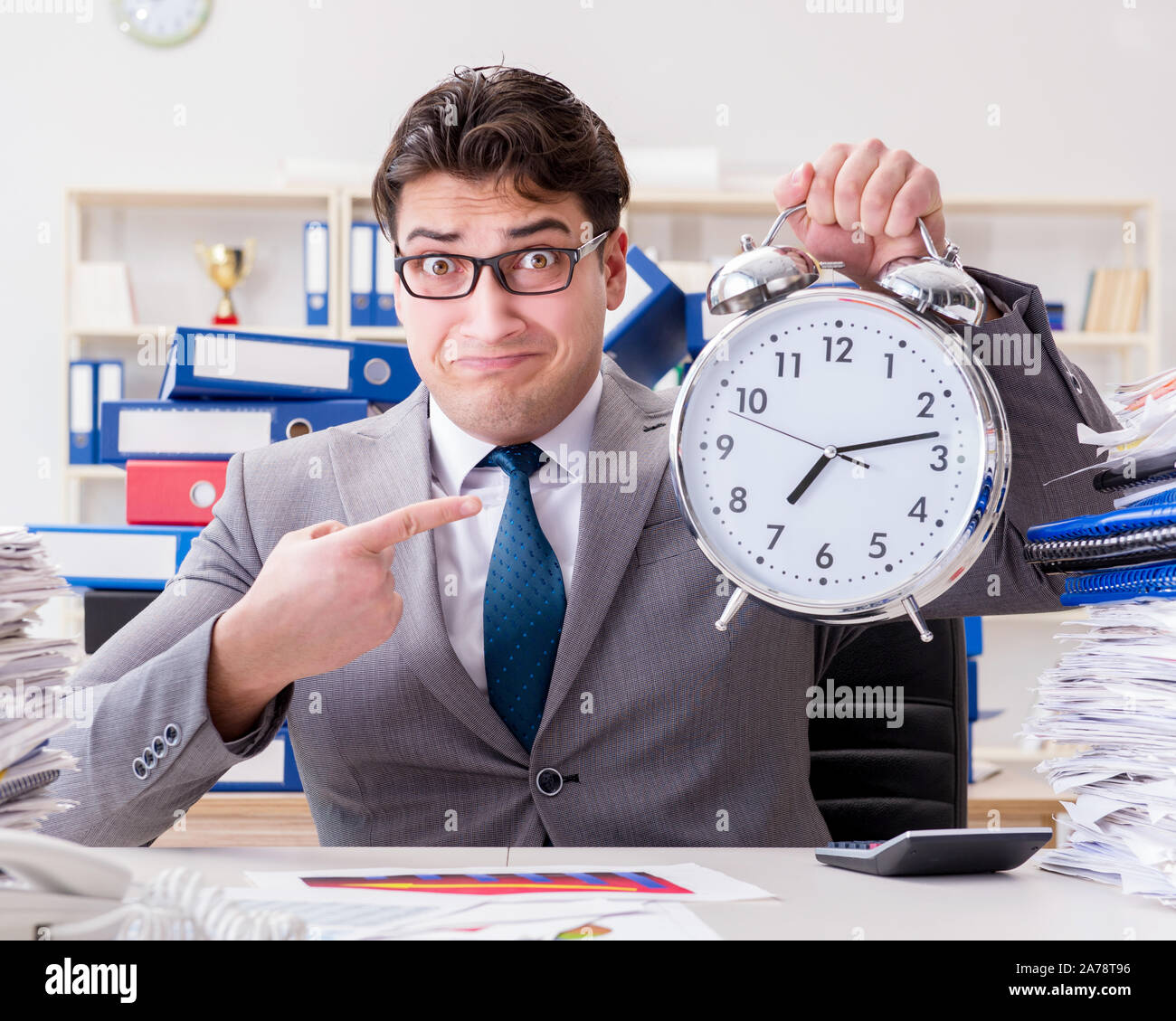 The businessman missing deadlines due to excessive work Stock Photo - Alamy