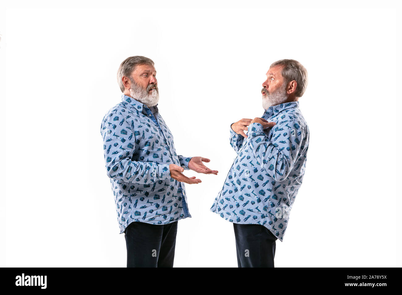 Senior man arguing with himself on white studio background. Concept of ...