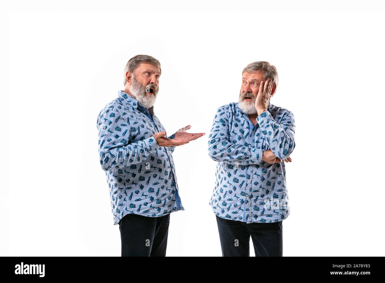 Senior man arguing with himself on white studio background. Concept of ...