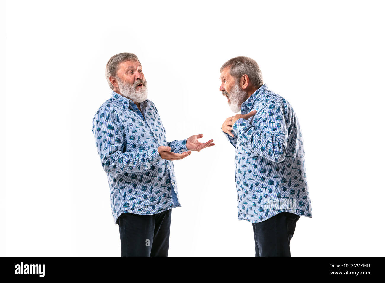 Senior man arguing with himself on white studio background. Concept of ...