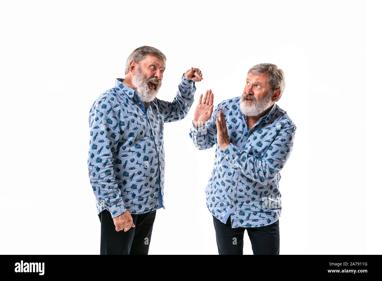 Senior man arguing with himself on white studio background. Concept of ...