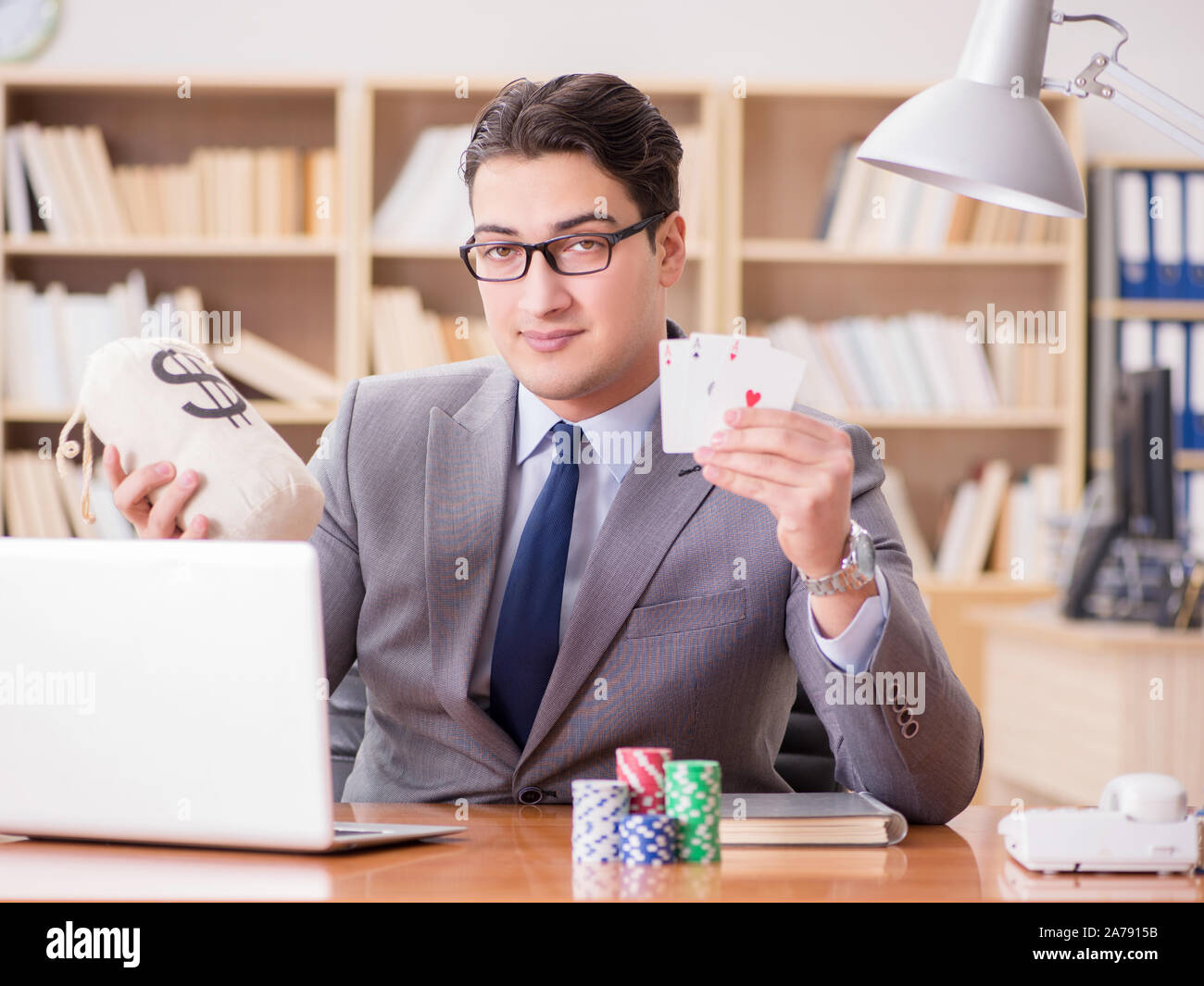 The businessman gambling playing cards at work Stock Photo - Alamy