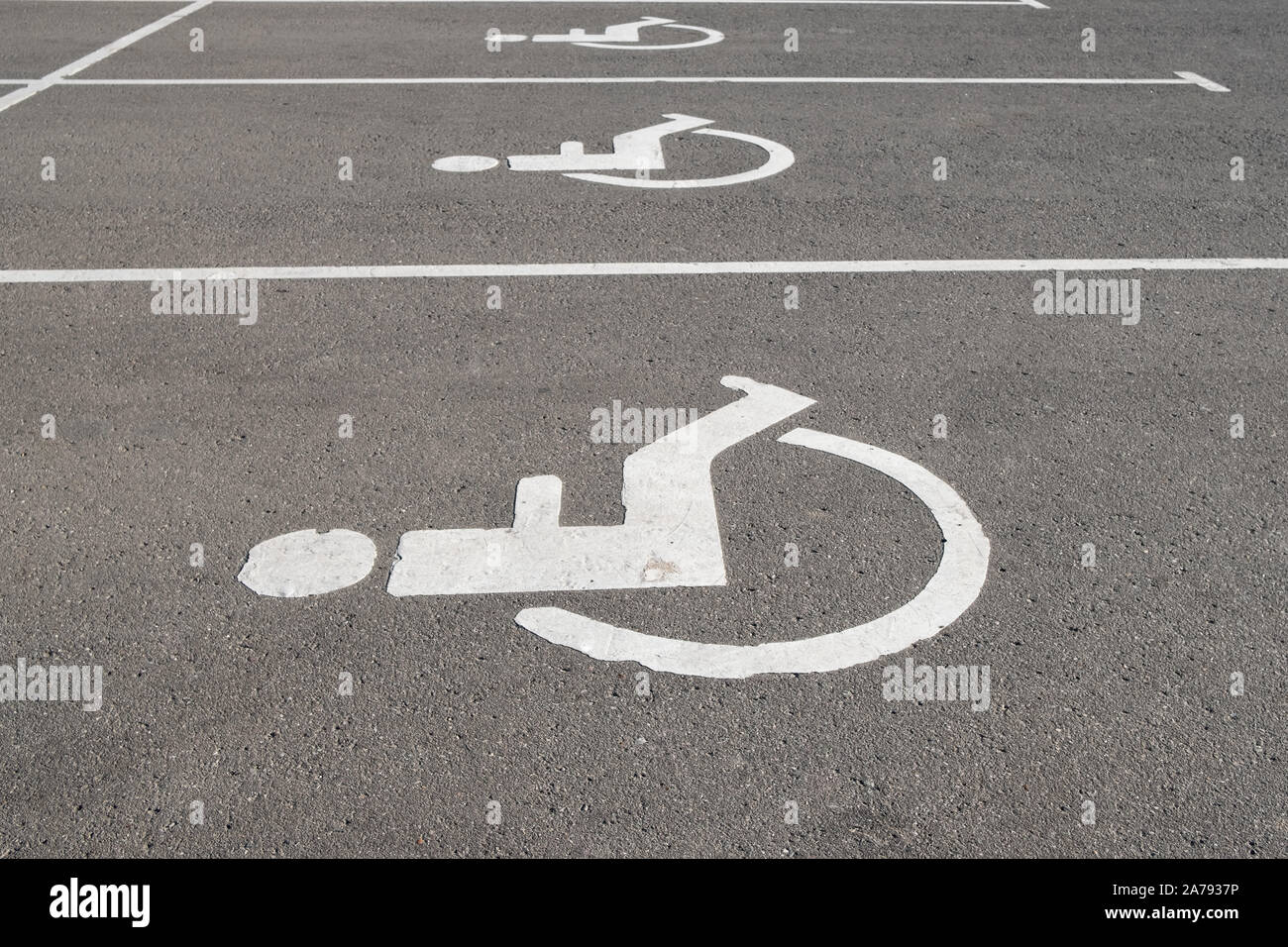 Disabled parking sign in a parking space. Symbol of a person in a ...