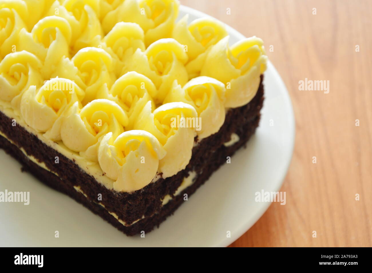 cream decorate rose flower topping chocolate cake on plate Stock Photo ...
