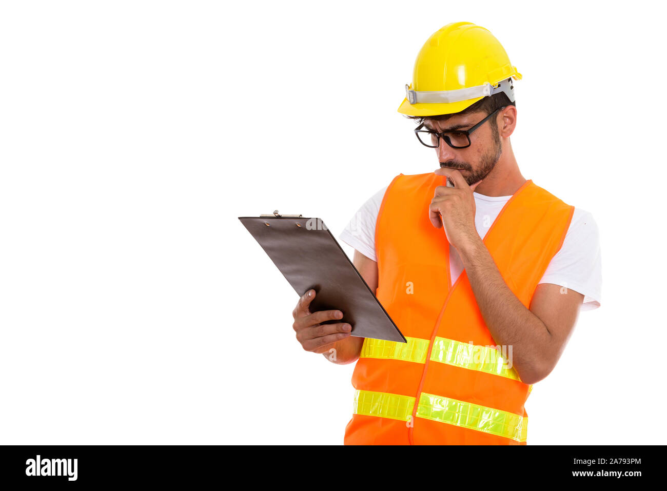 Studio shot of young Persian man construction worker thinking wh Stock ...
