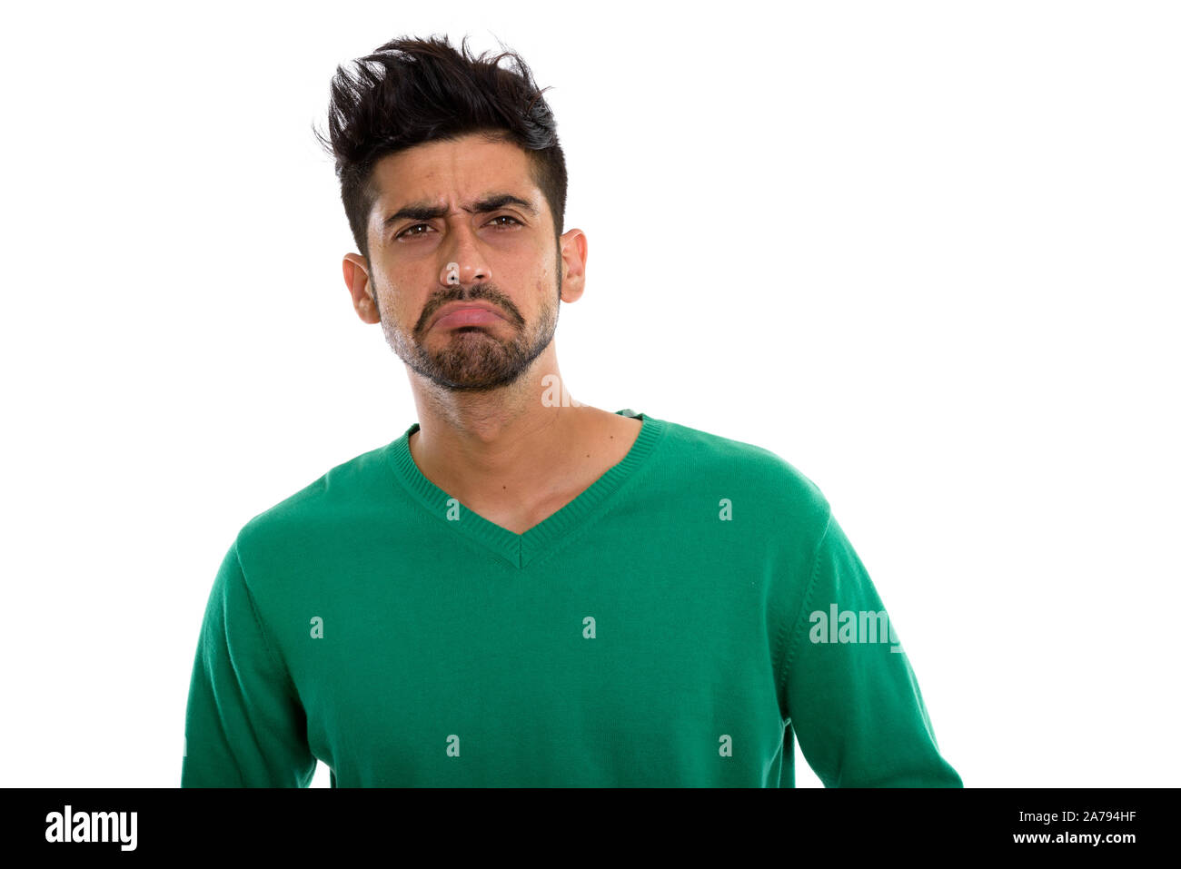 Studio shot of young Persian man looking sad Stock Photo - Alamy