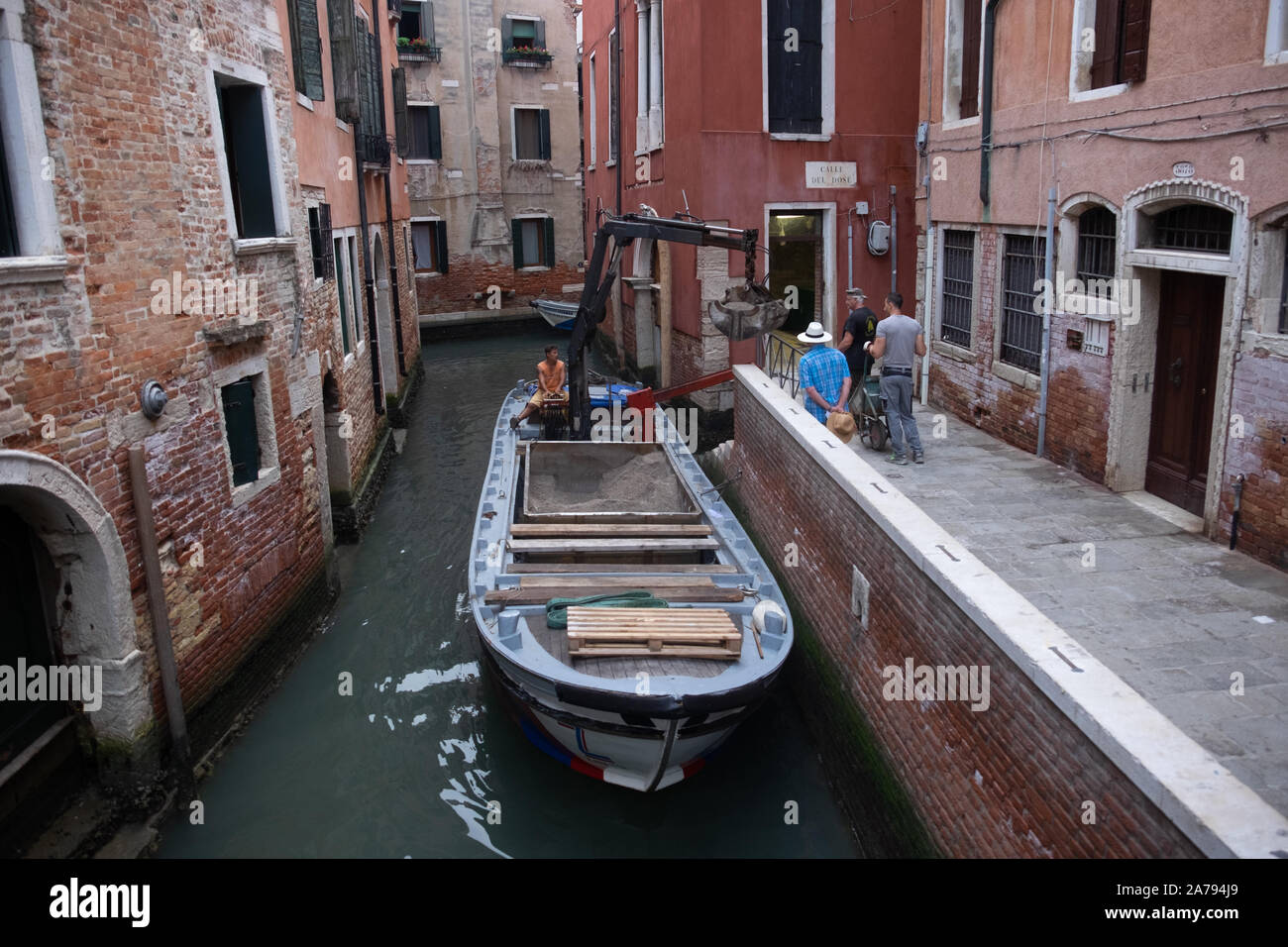 Delivery barges, long, slim navigating the extremely narrow waterways ...