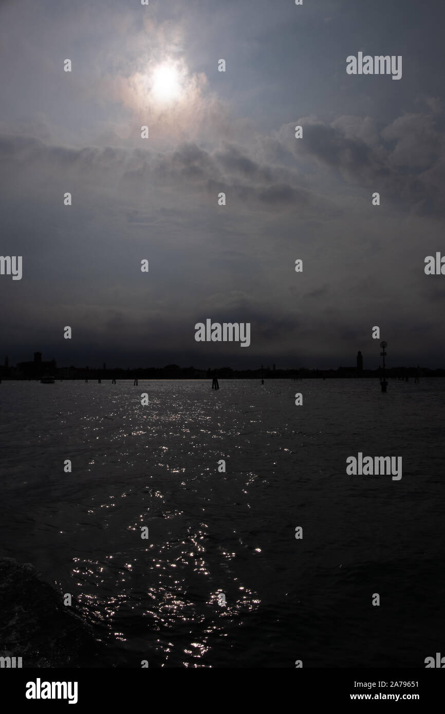Dark, brooding, overcast sky views of the colourful buildings of Murano ...