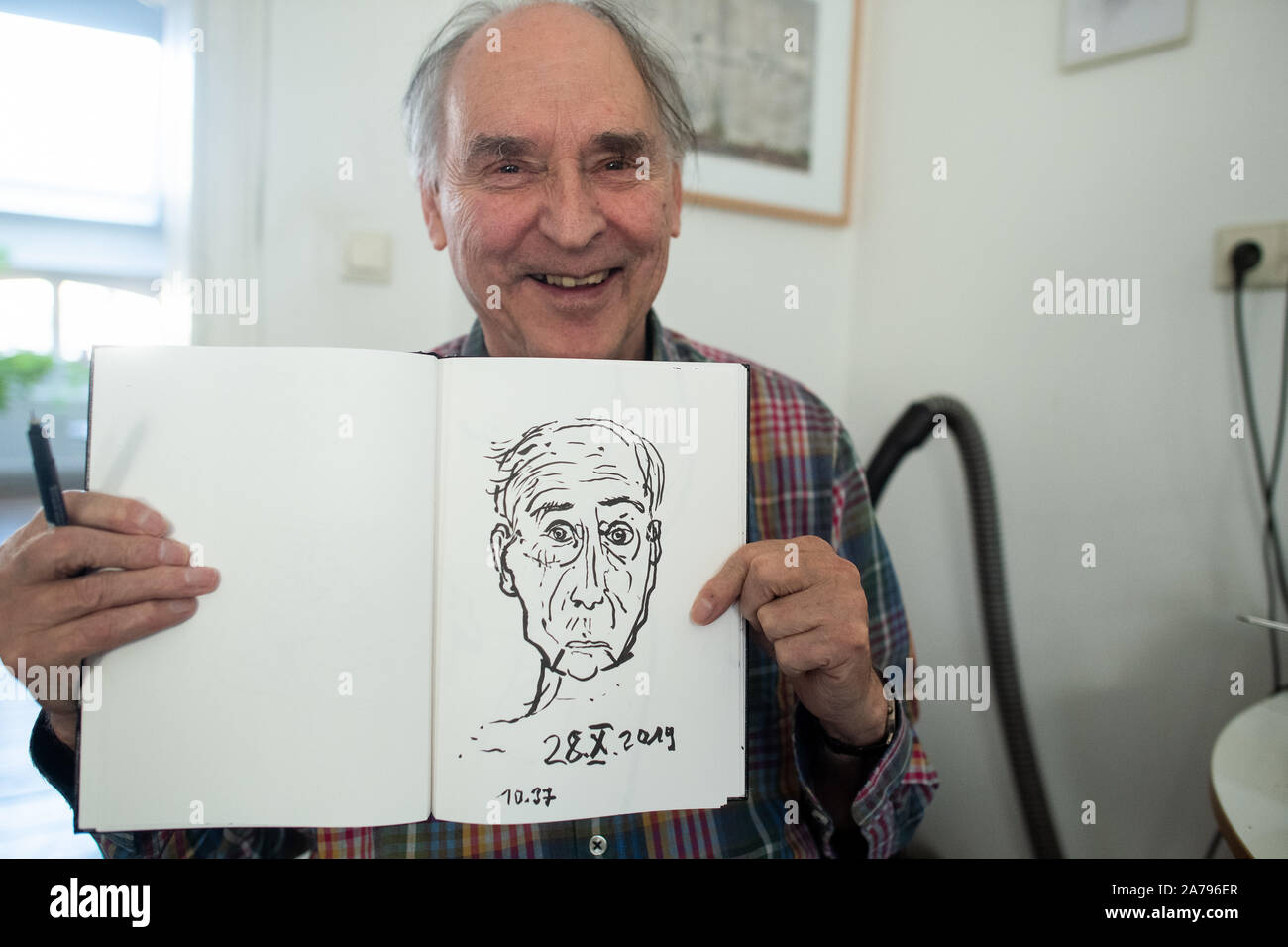 Duesseldorf, Germany. 31st Oct, 2019. Harald Naegeli, artist, holds his ...