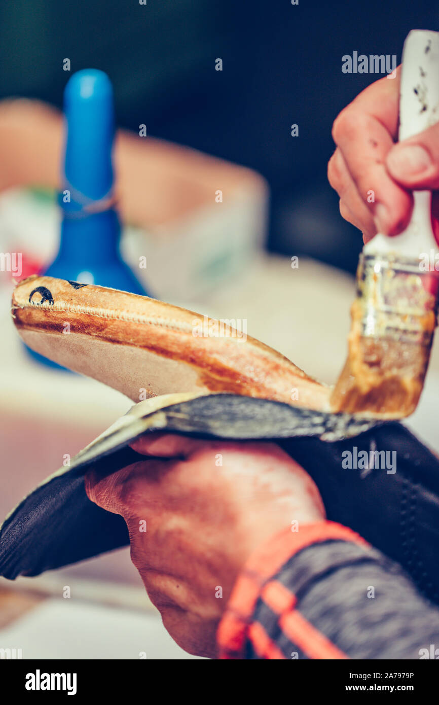 Hands of an experienced worker in the handmade footwear industry ...