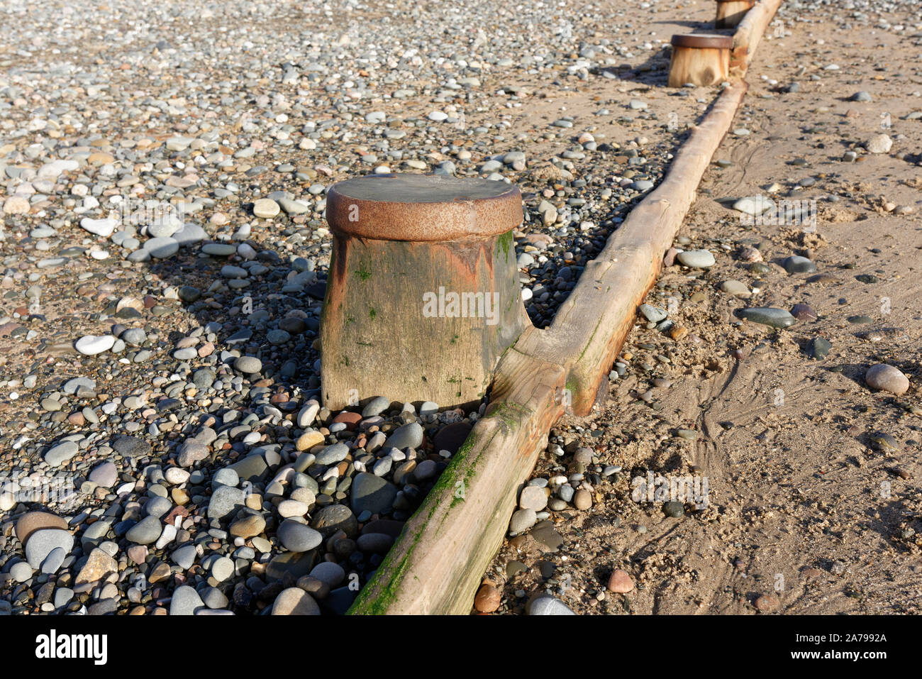 Timber groyne covered by shingle and sand, coastal deposition in ...