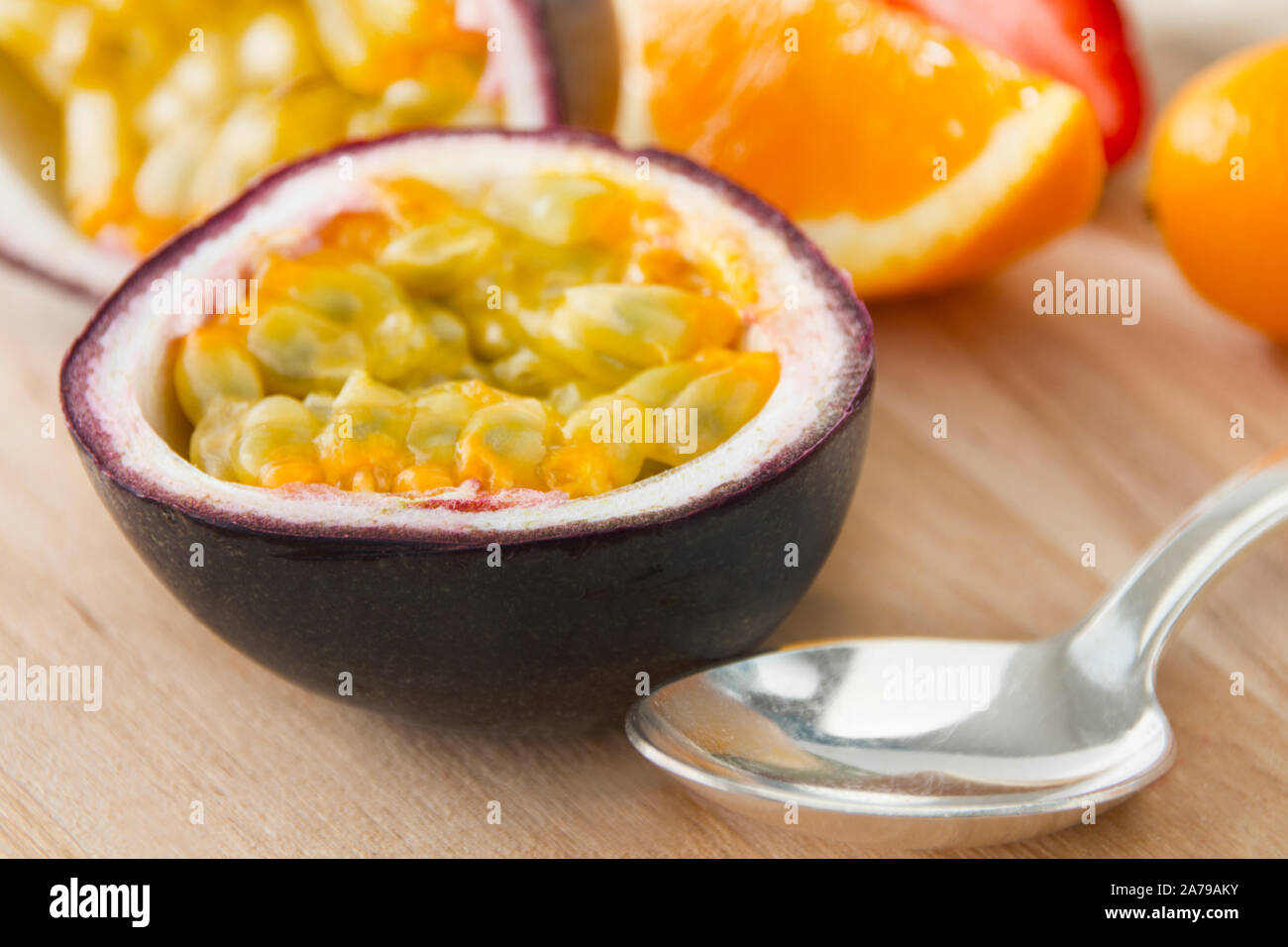 Passion fruit with spoon Stock Photo - Alamy