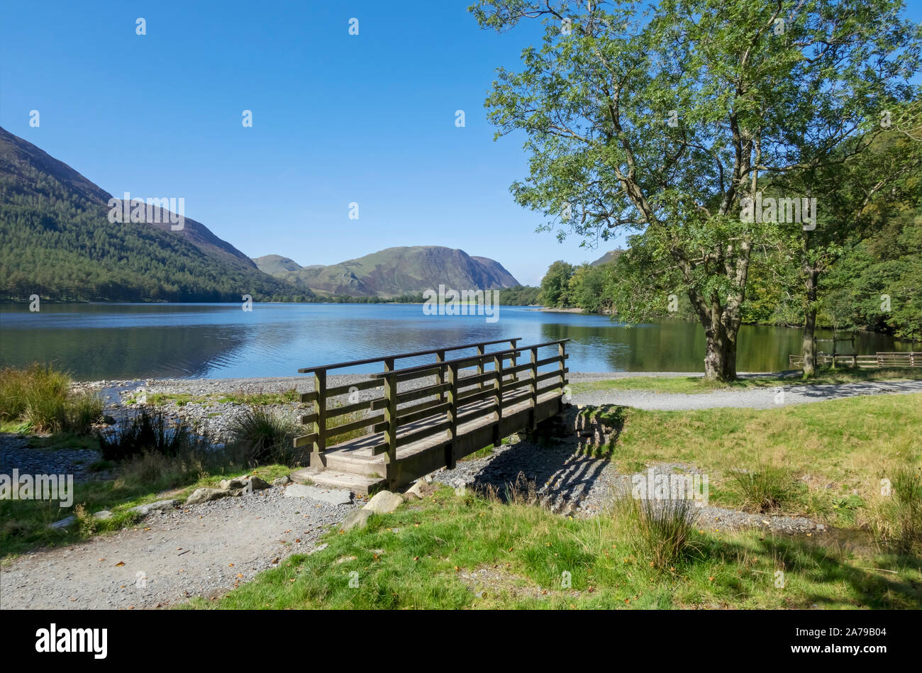 Footbridge footpath walk path across wooden bridge on the shore of ...