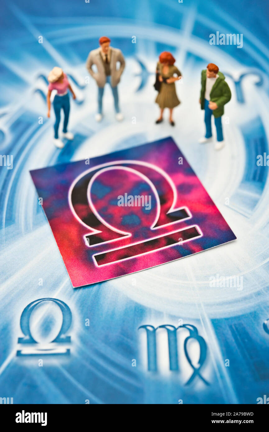 people miniature figurines and zodiac sign of Libra Stock Photo - Alamy