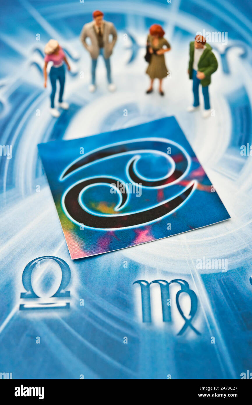 people miniature figurines and zodiac sign of Cancer Stock Photo - Alamy