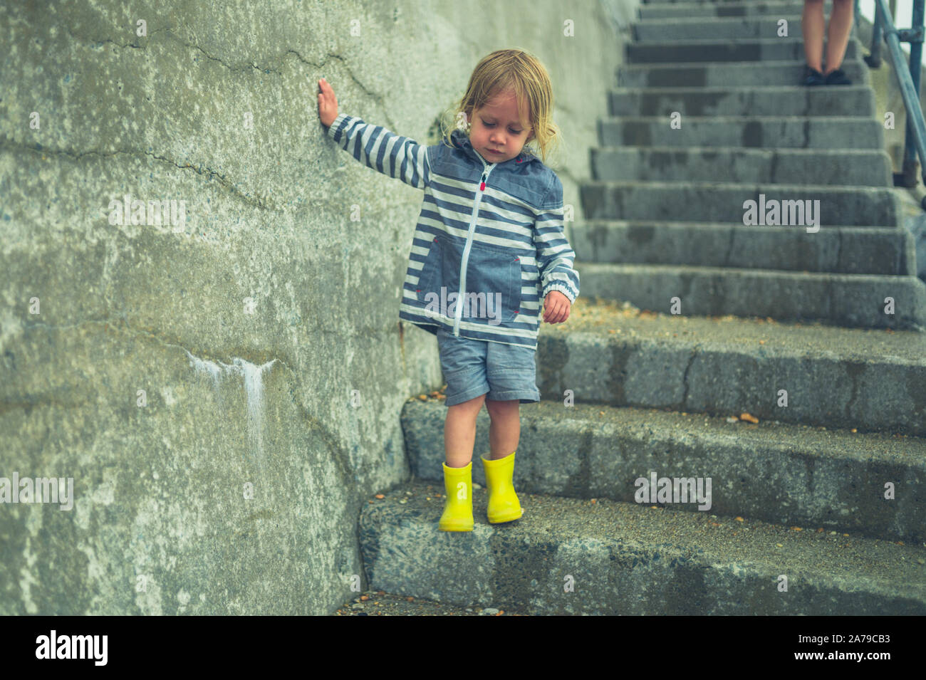 Child walking down steps hi-res stock photography and images - Alamy
