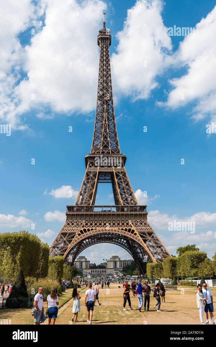The Eiffel Tower against blue and cloudy sky, a wrought-iron lattice ...