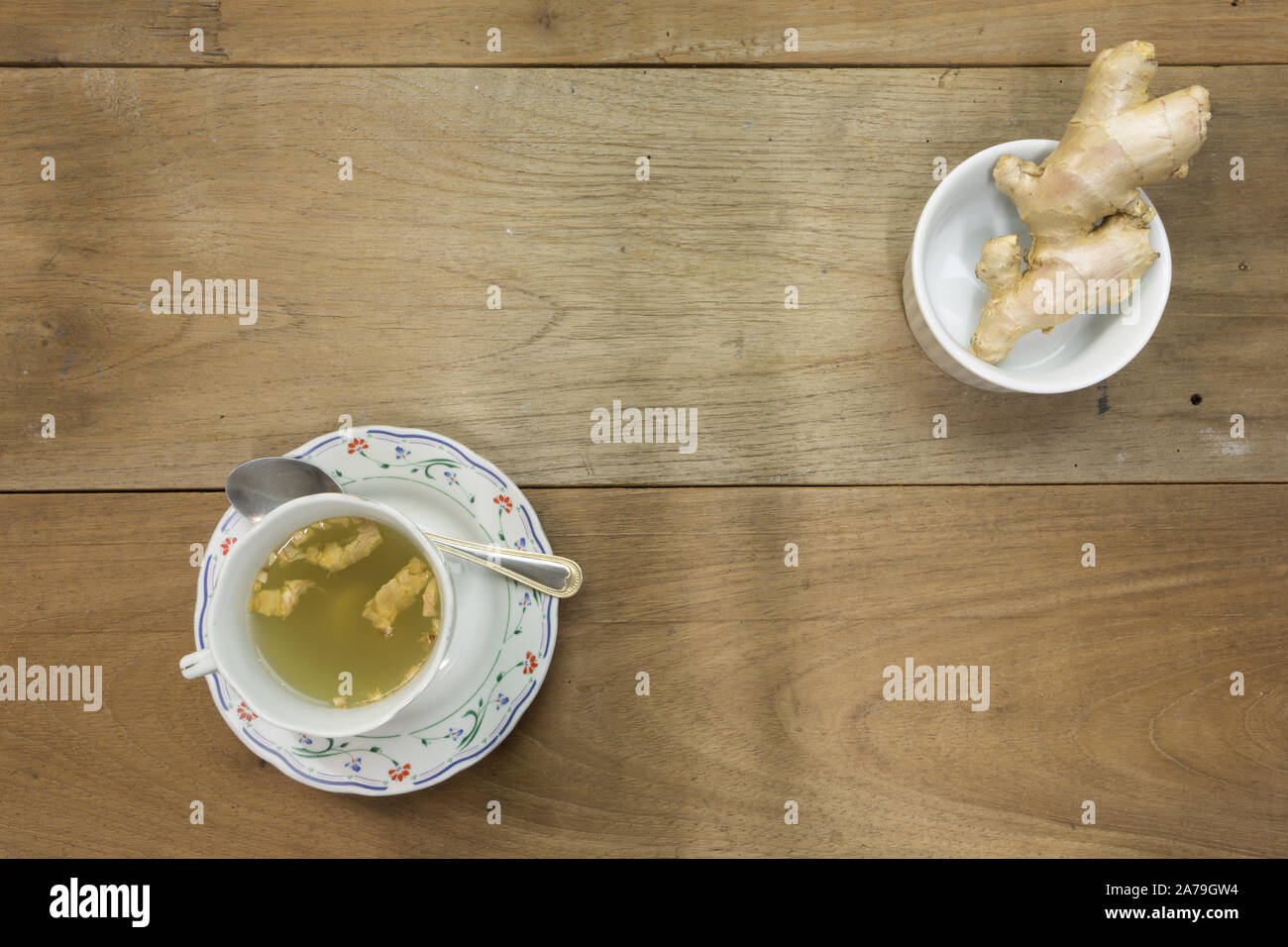Hot ginger tea in ceramic teacup with raw ginger root, fresh ginger ...