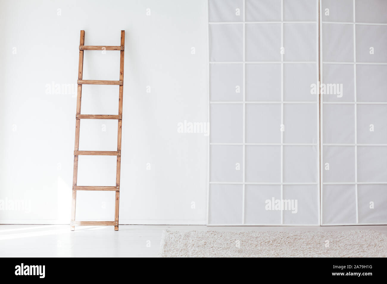 wooden staircase against the wall in the white room Stock Photo - Alamy