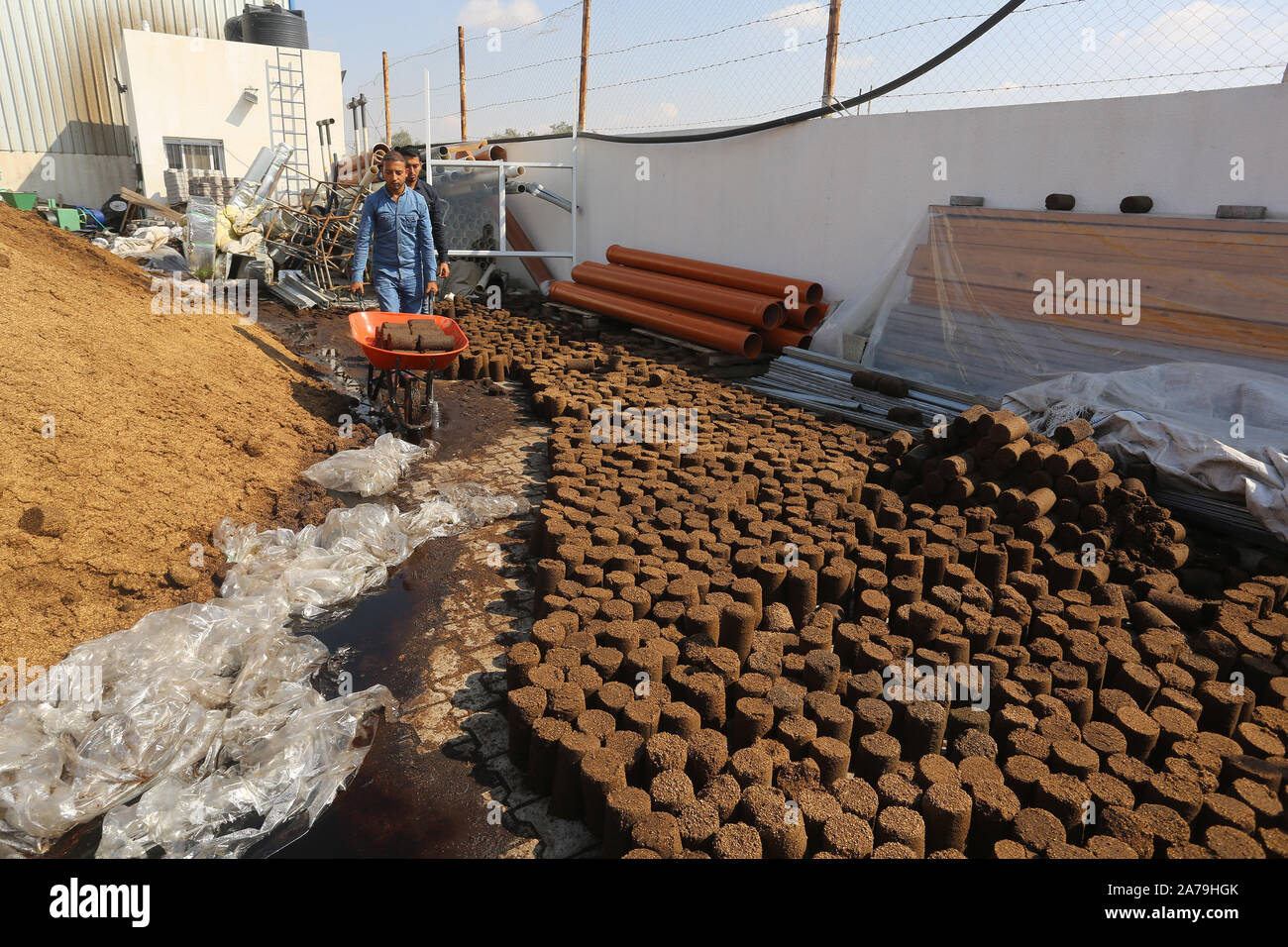 Palestinians make molds from olive pomace that is obtained from the ...