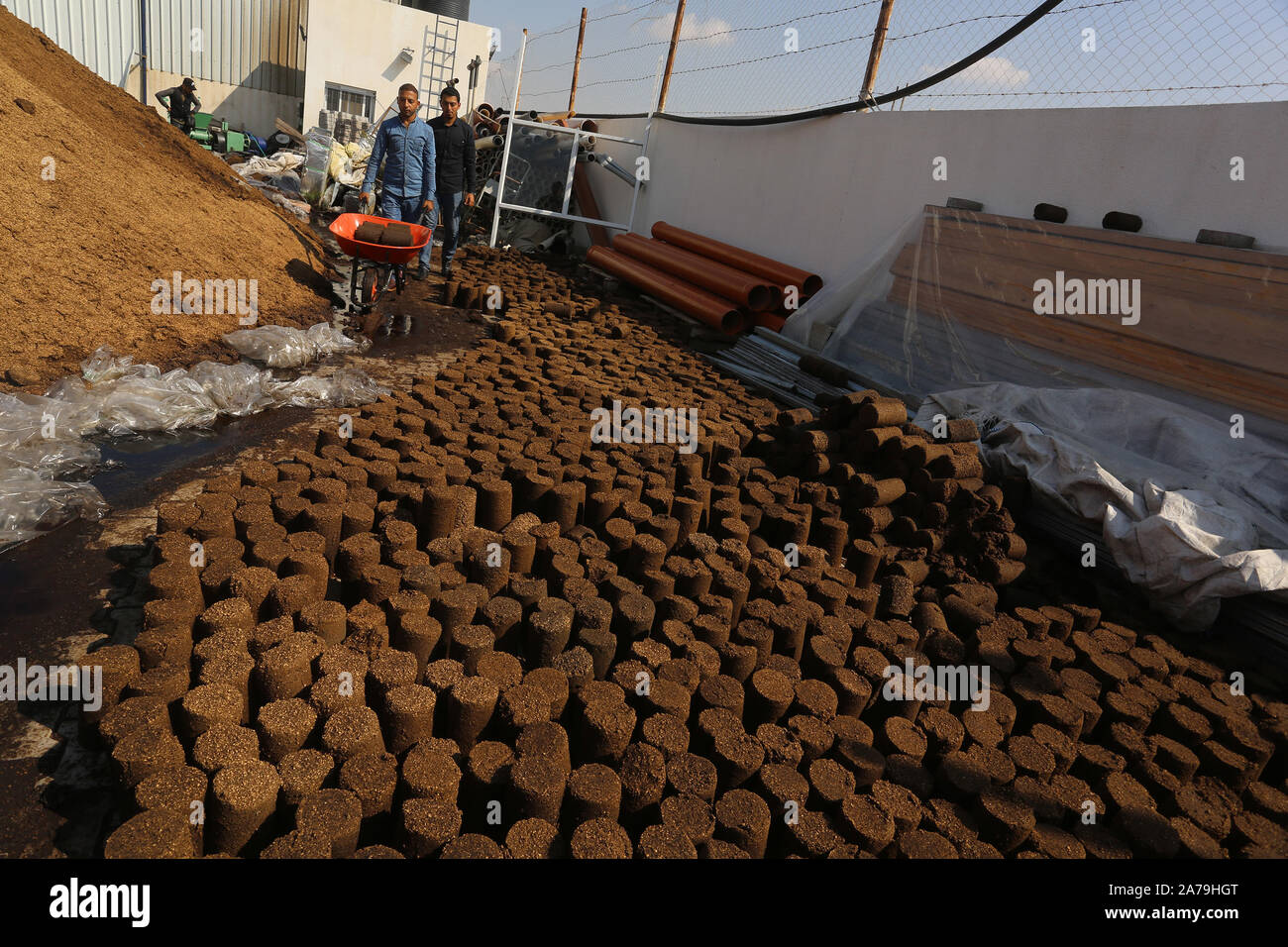 Palestinians make molds from olive pomace that is obtained from the ...