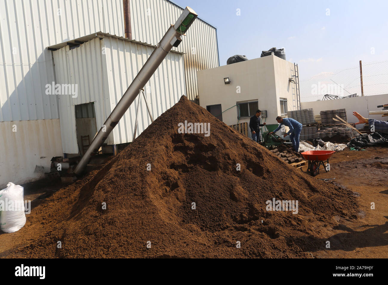 Palestinians make molds from olive pomace that is obtained from the ...