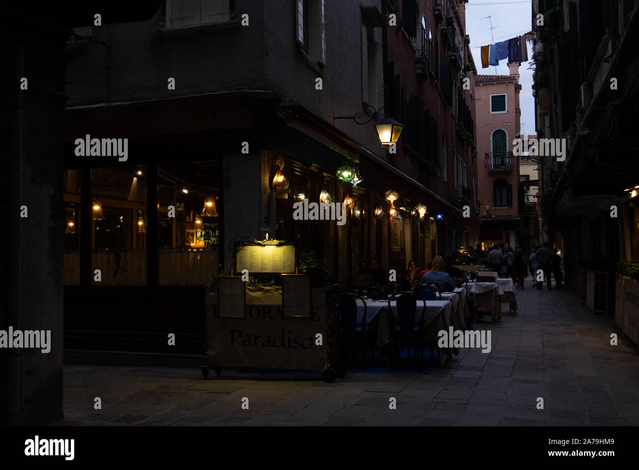 Lowering light to dusk in the shopping streets of Venice lit with the ...