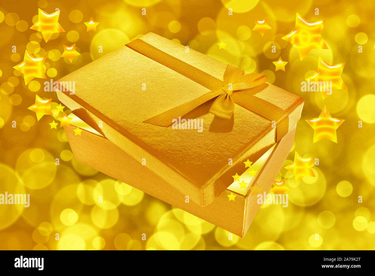 Golden gift box with stars on golden bokeh Stock Photo - Alamy
