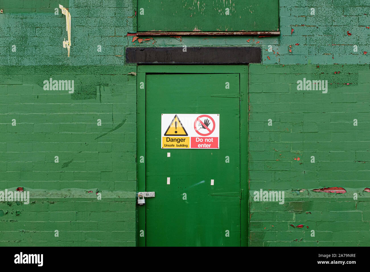 Green door on a green building with a ' Danger keep out' sign Stock ...