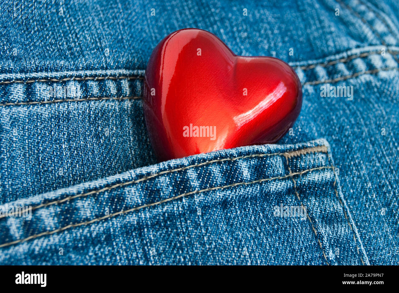 Red heart in jeans pocket Stock Photo - Alamy