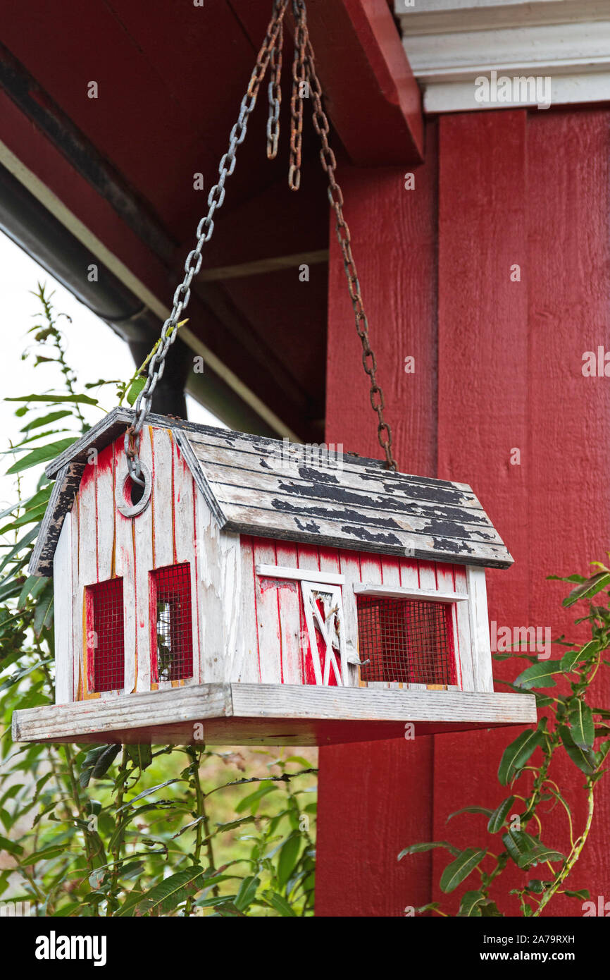 Small Bird House in Shape of Barn Hanging Outside Stock Photo - Alamy