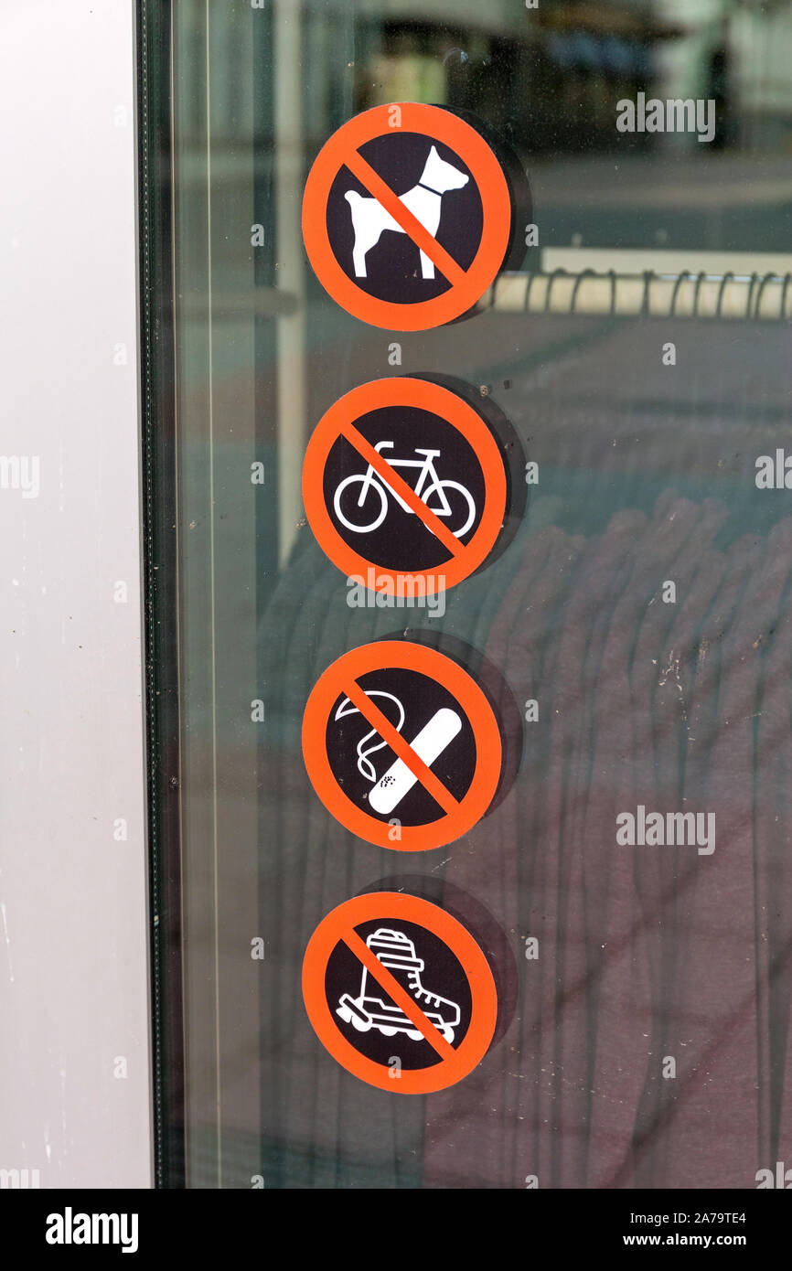 Four Restrictions Warning Signs at Glass Door Stock Photo - Alamy