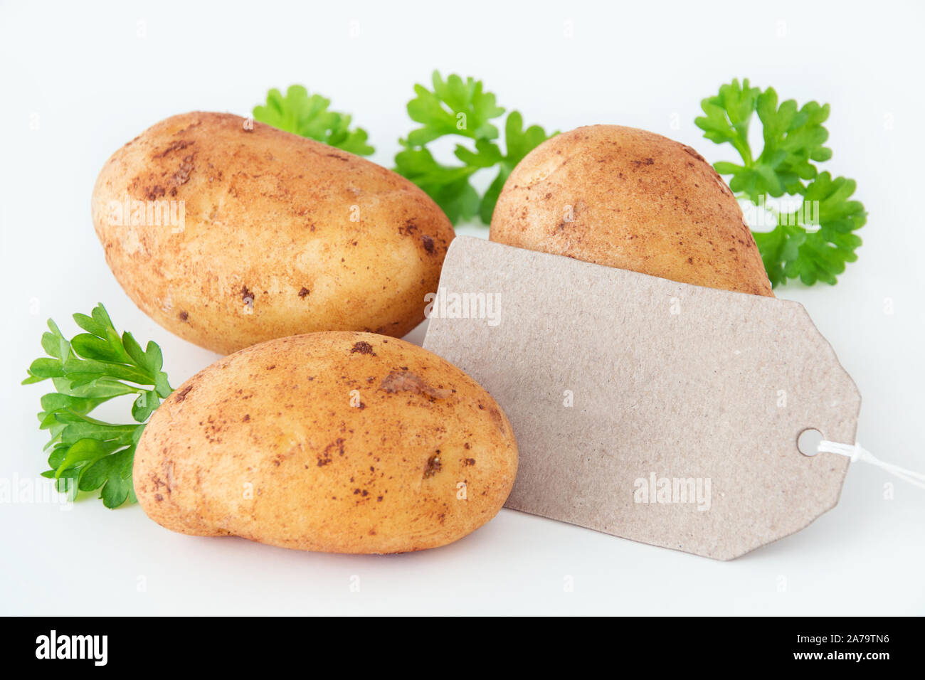 Potatoes on white background with label Stock Photo - Alamy