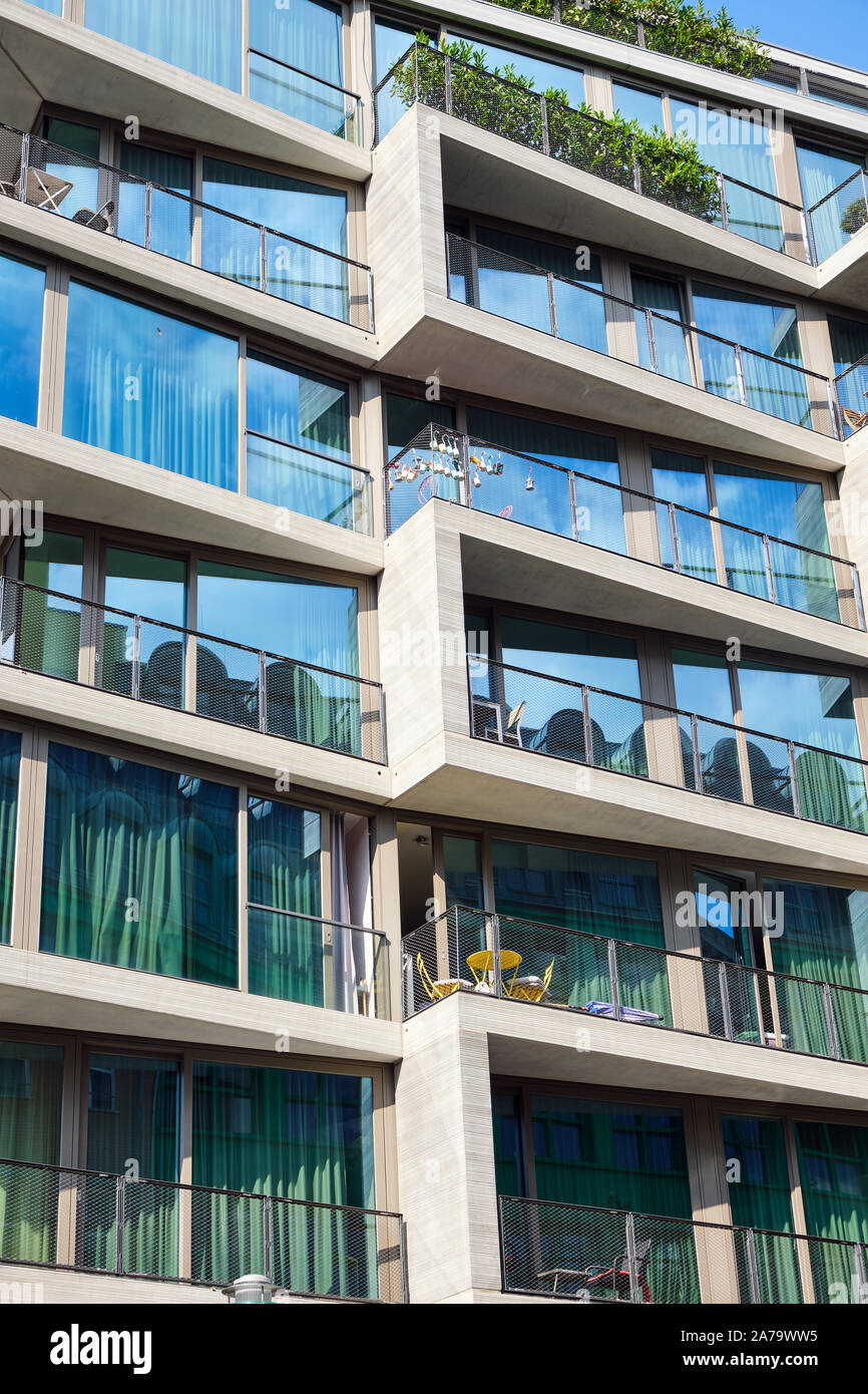 Detail of an apartment building with floor-to-ceiling windows seen in ...